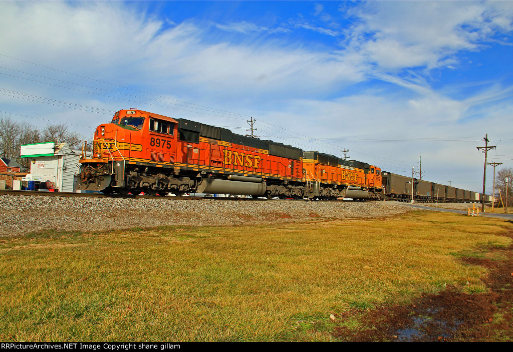BNSF 8975 leads a SB coal under the blue skys,